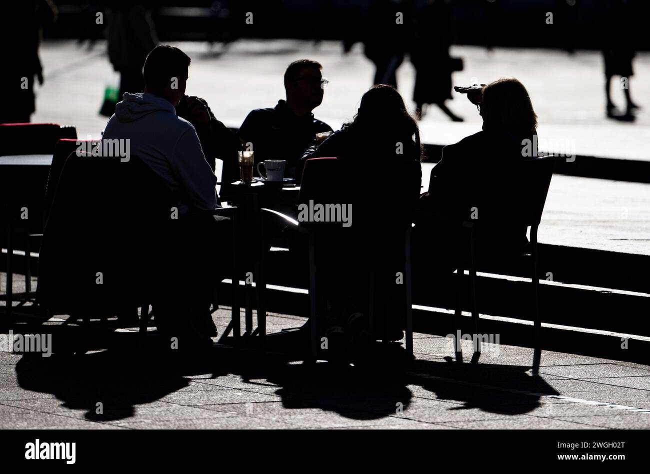 Stuttgart, Germany. 05th Feb, 2024. People sit in the sunshine at a ...