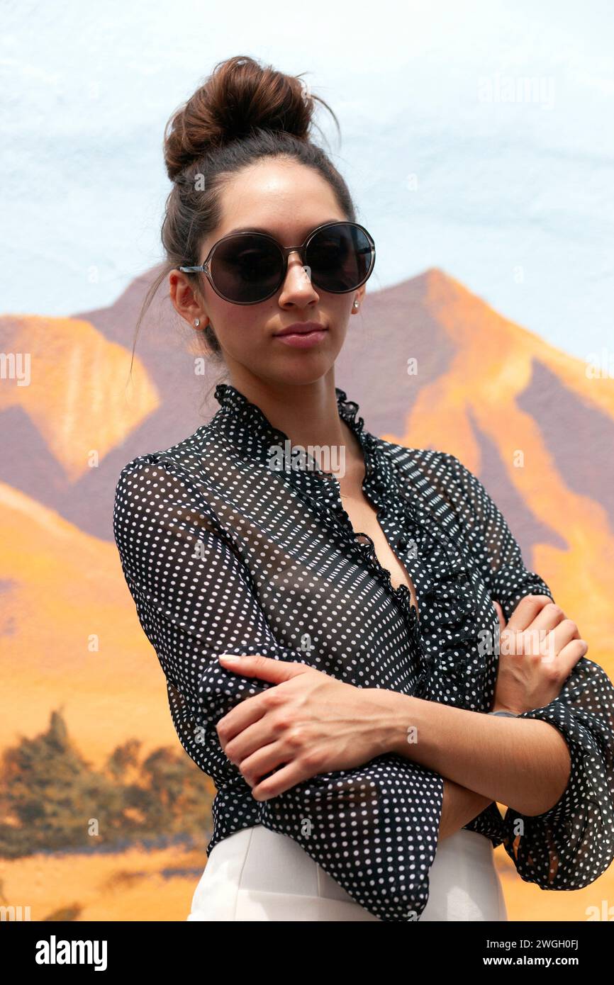 A female model wearing round sunglasses looking vertical Stock Photo ...