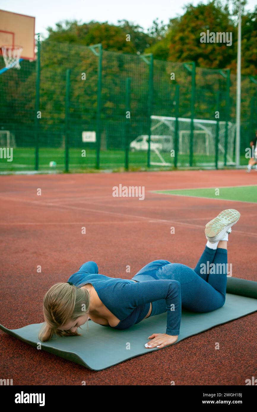 Vertical cropped photo of young pretty caucasian female athlete doing ...
