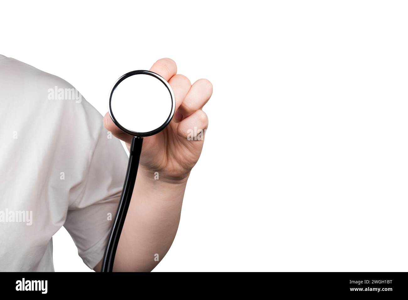 The head of a medical stethoscope in a hand, close-up, isolated on a ...