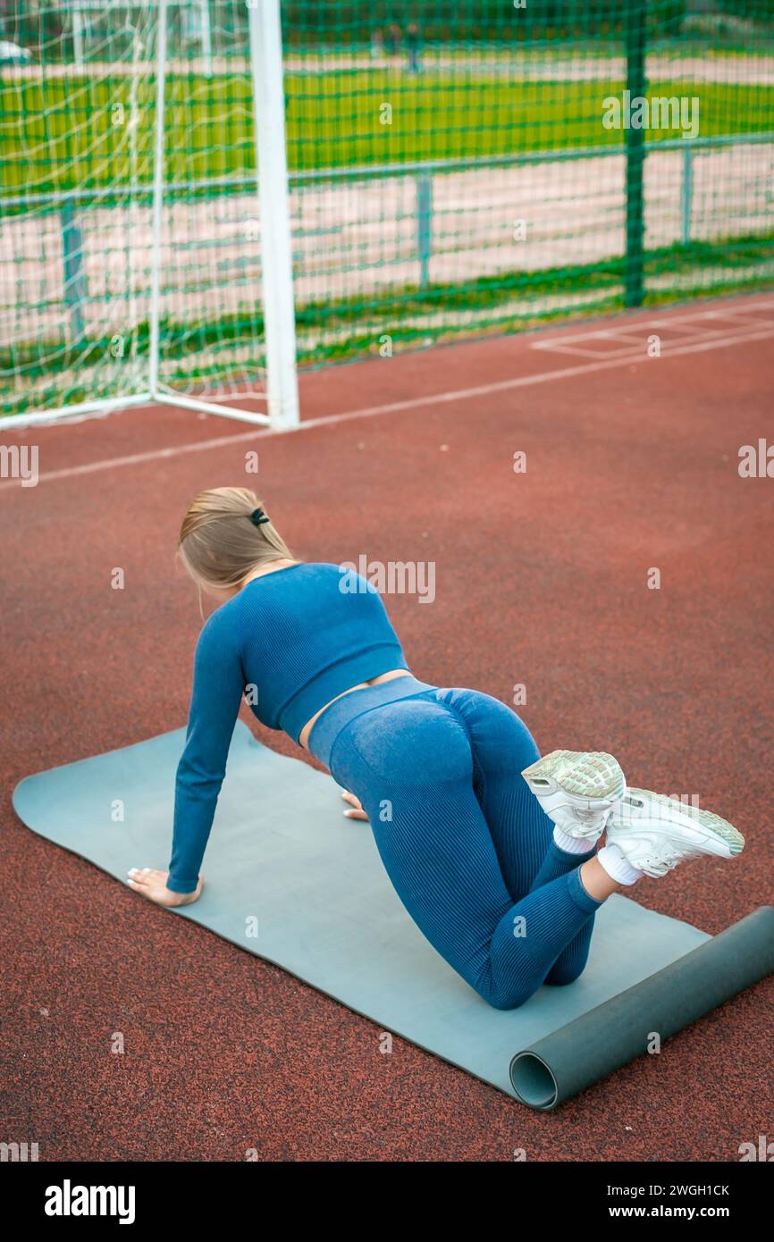 Vertical cropped photo of young pretty caucasian female athlete doing ...