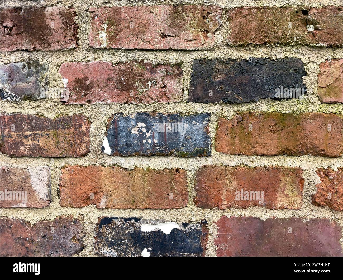 A rustic mixed colour brick wall with scruffy mortar Stock Photo - Alamy