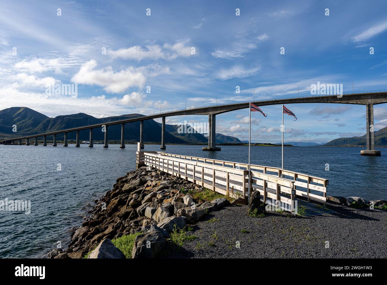 A scenic bridge spanning across the vast ocean, leading towards a ...
