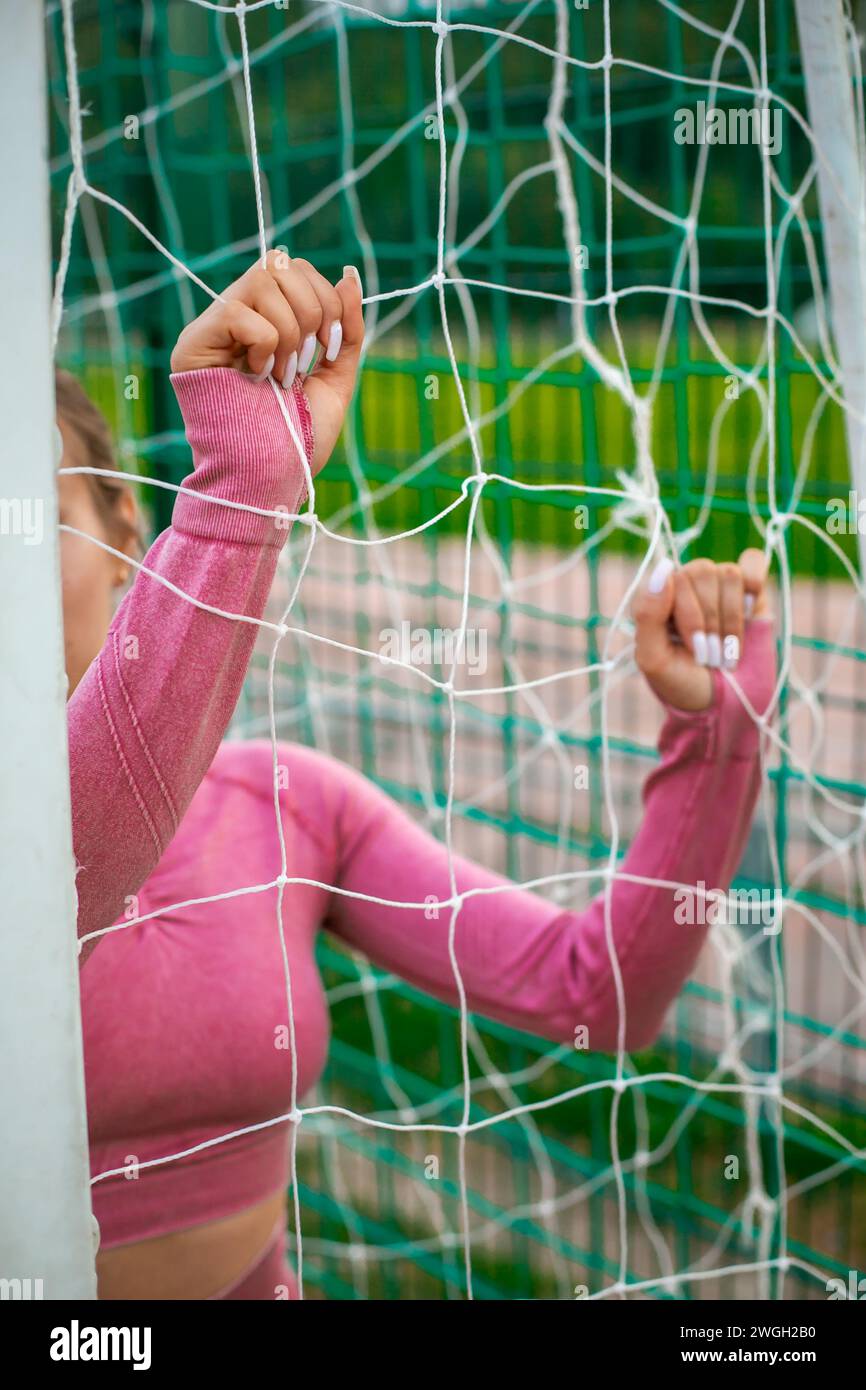 Girl hands on the football gate mesh line, Hands on the mesh line ...