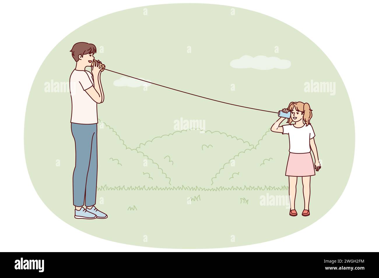 Little girl plays with father in park using cups tied with rope to talk ...