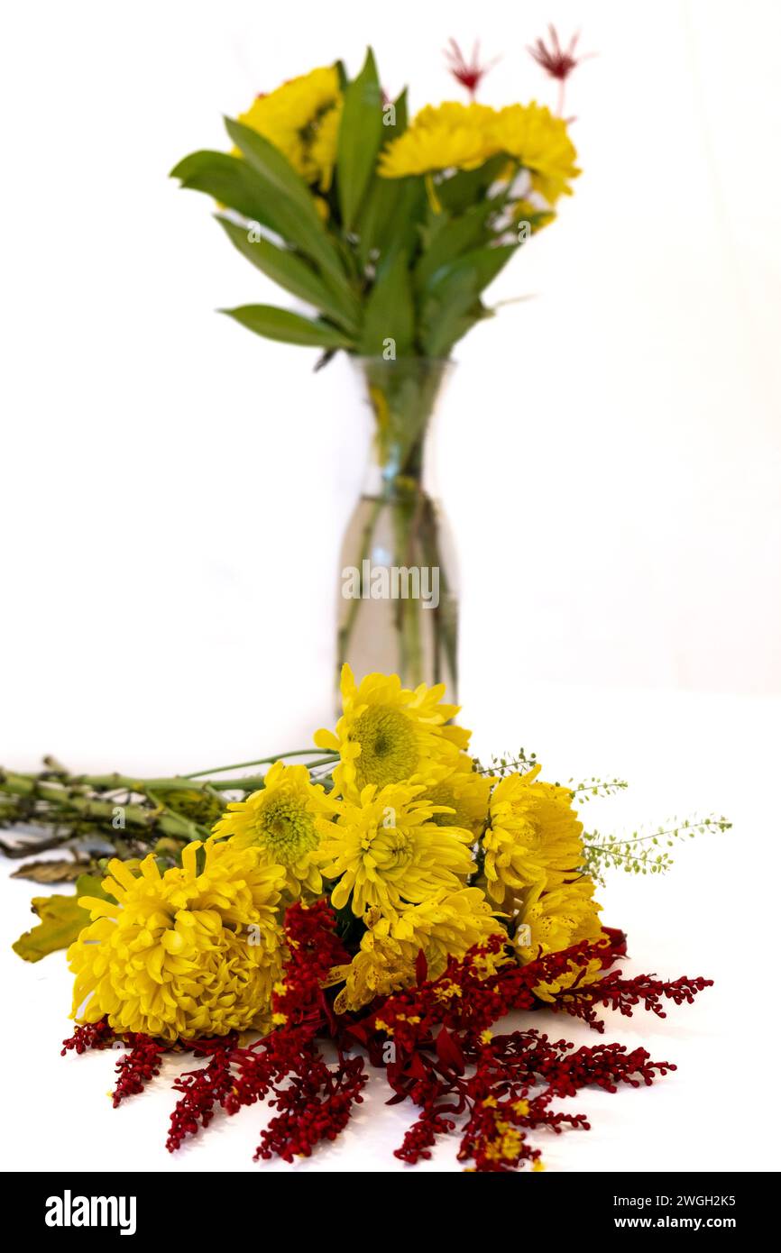 Yellow and red spring bouquet of flowers on a light background Stock ...