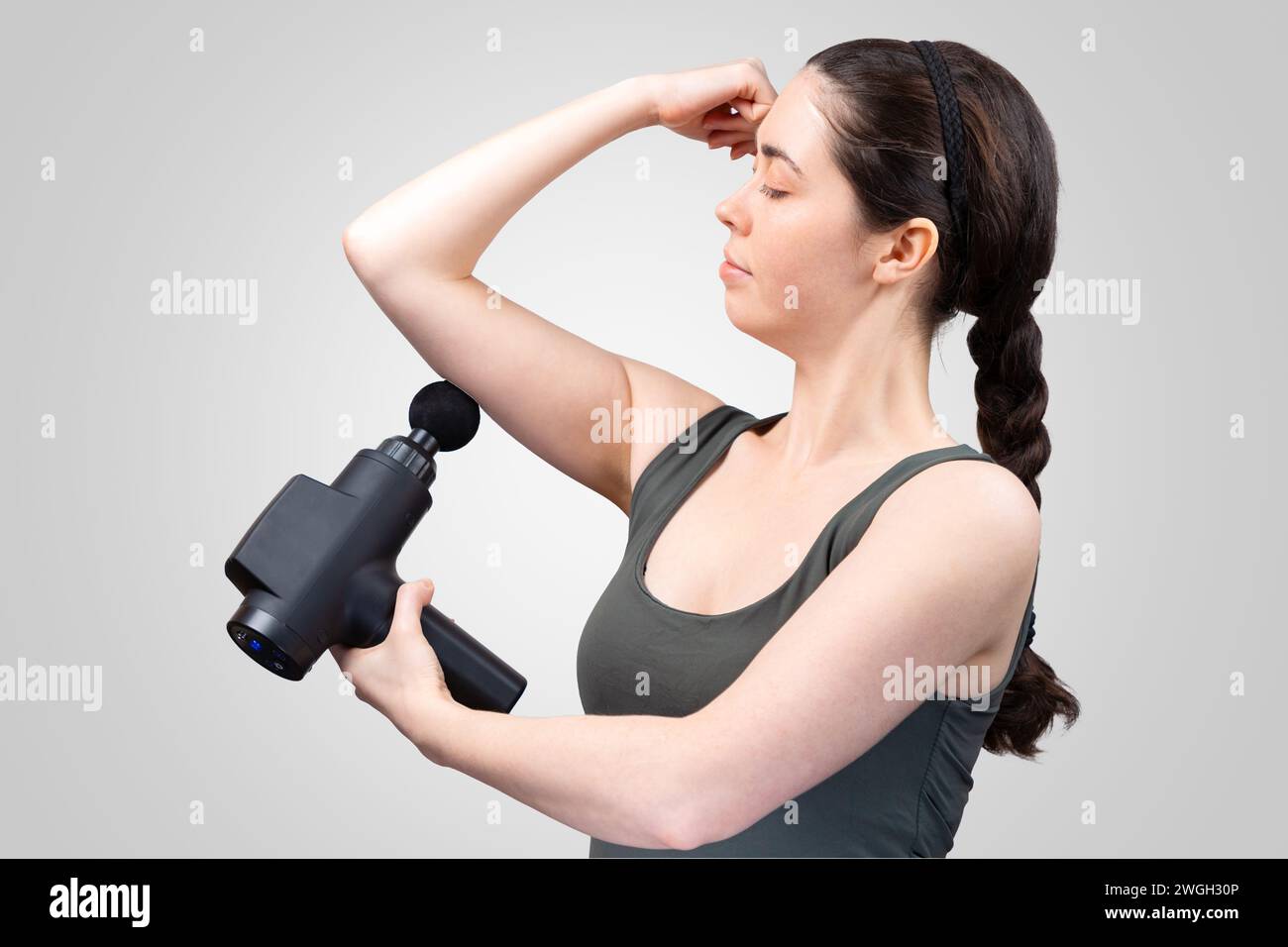 Side View Of Adult Pretty Caucasian Woman Gives Herself Massage On Arm