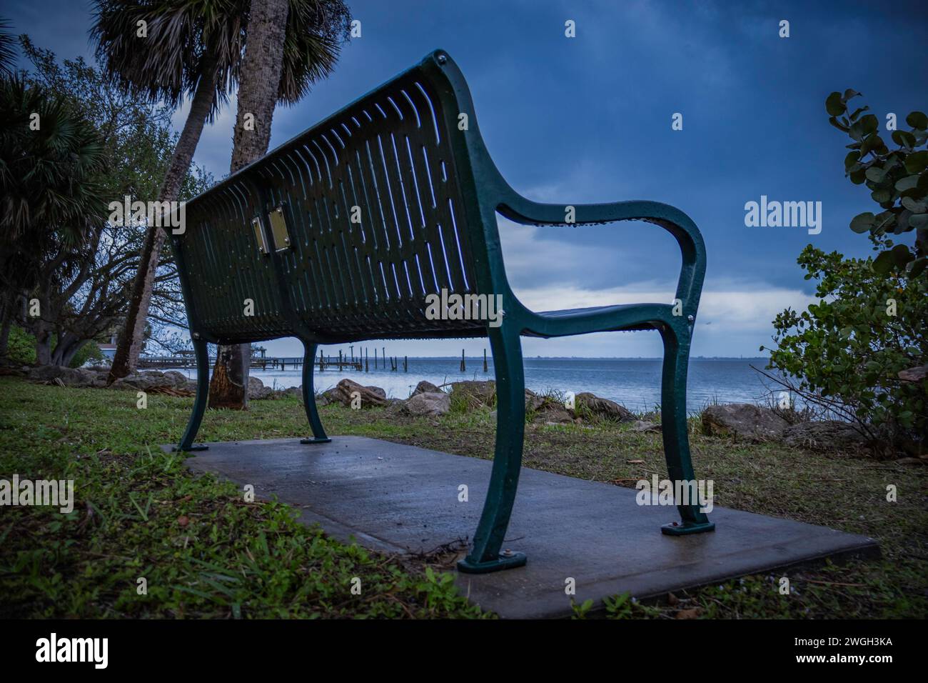 Park bench over river Stock Photo - Alamy