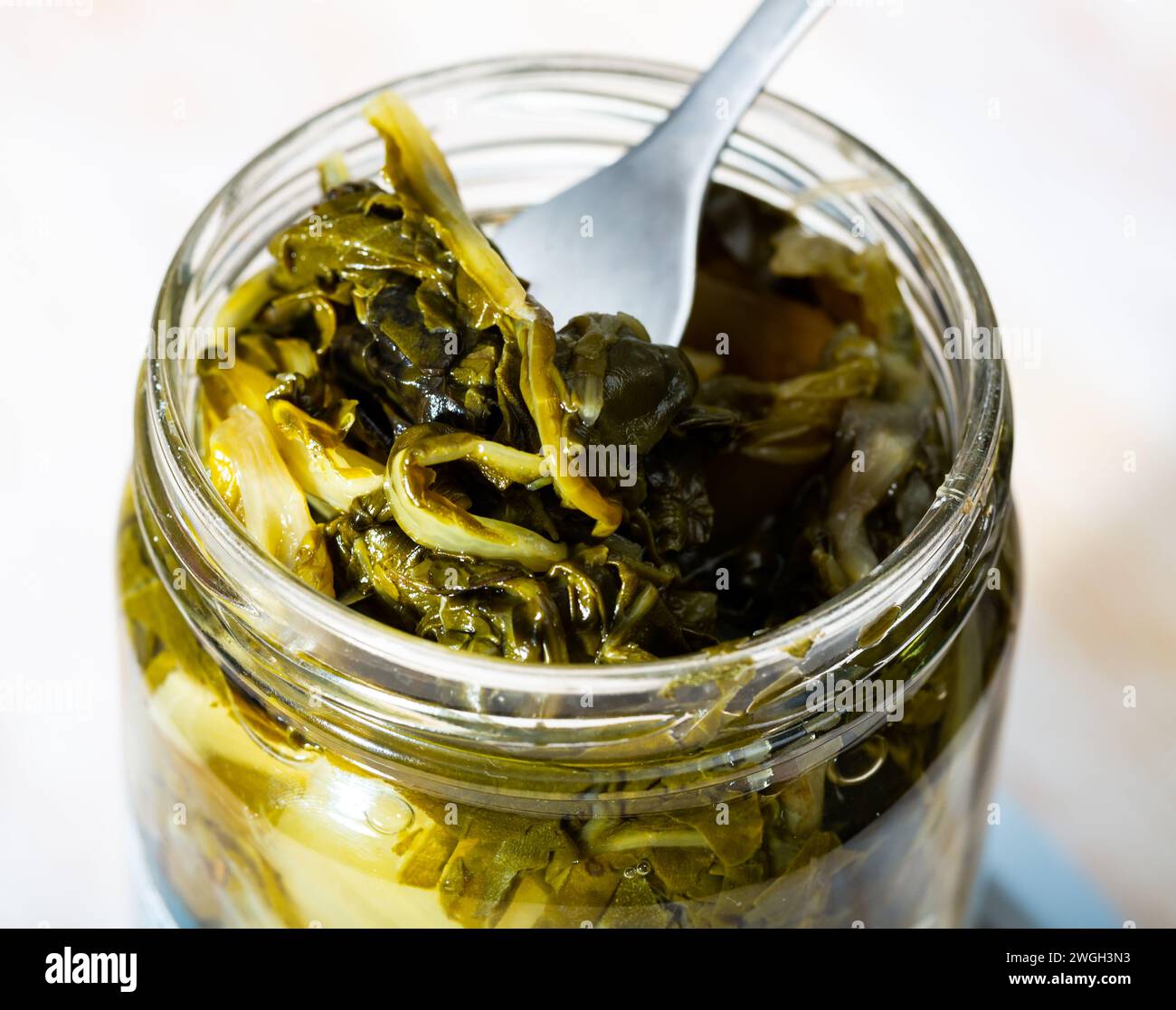 Pickled chard on fork in glass jar Stock Photo - Alamy