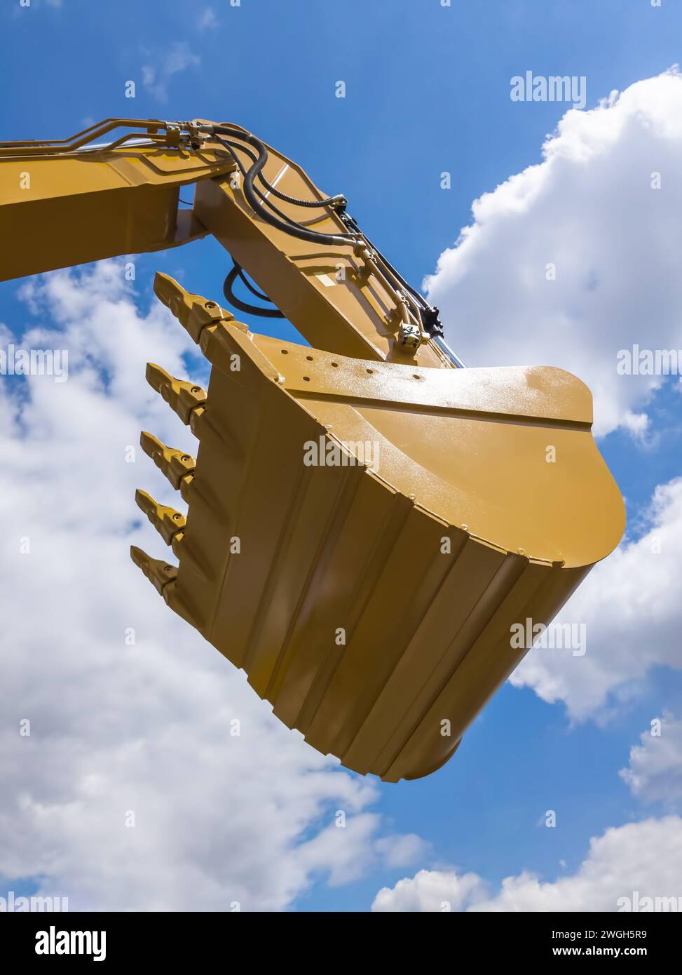 earth digger machine's scoop lifted Stock Photo - Alamy