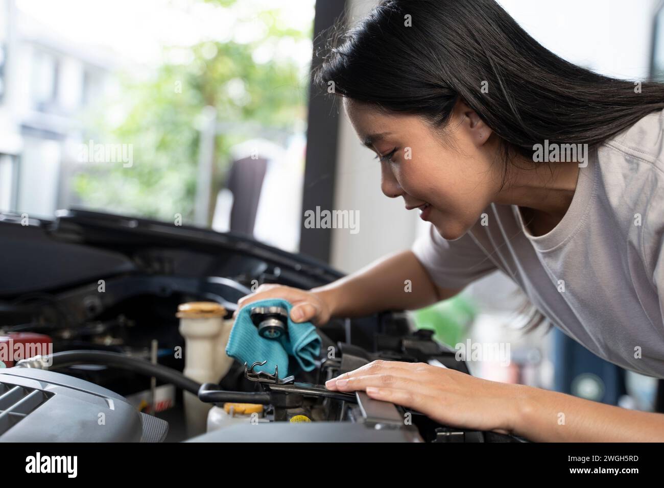 A woman is checking the engine coolant level Stock Photo - Alamy