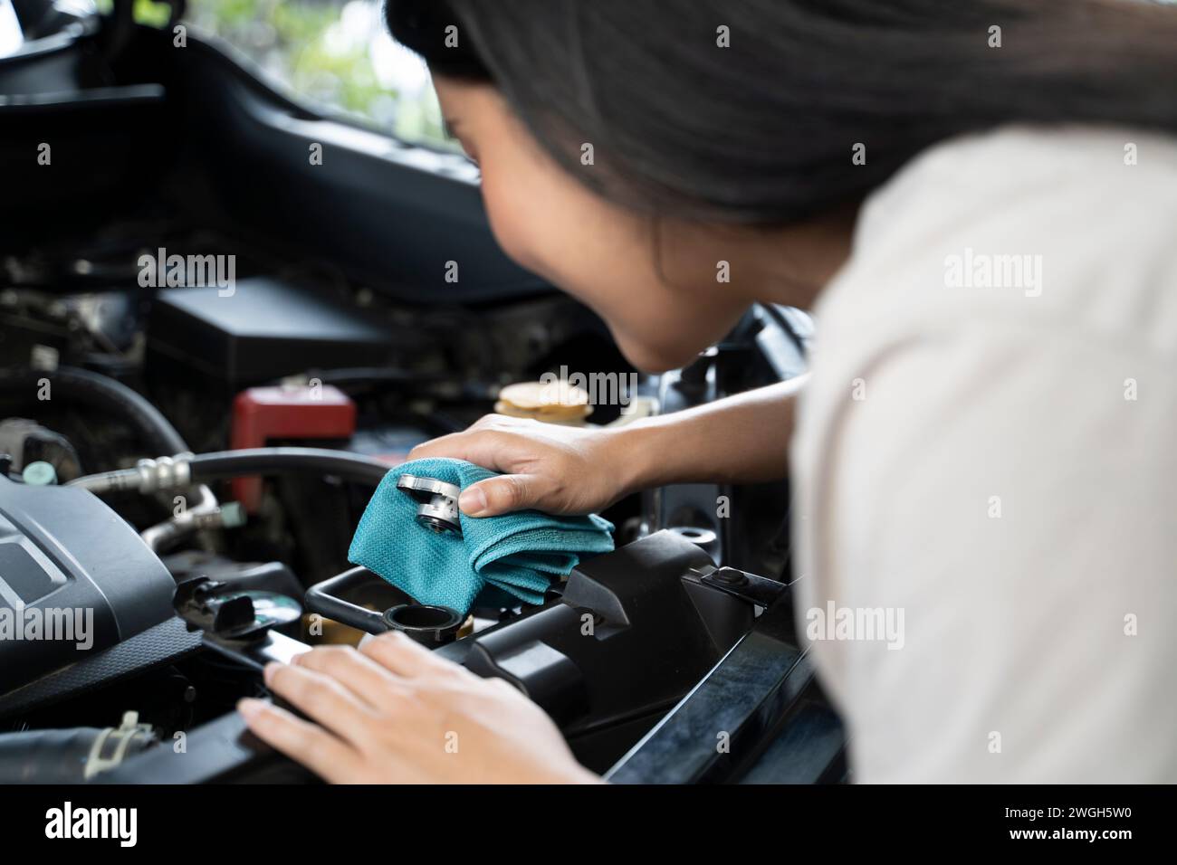A woman is checking the engine coolant level Stock Photo - Alamy
