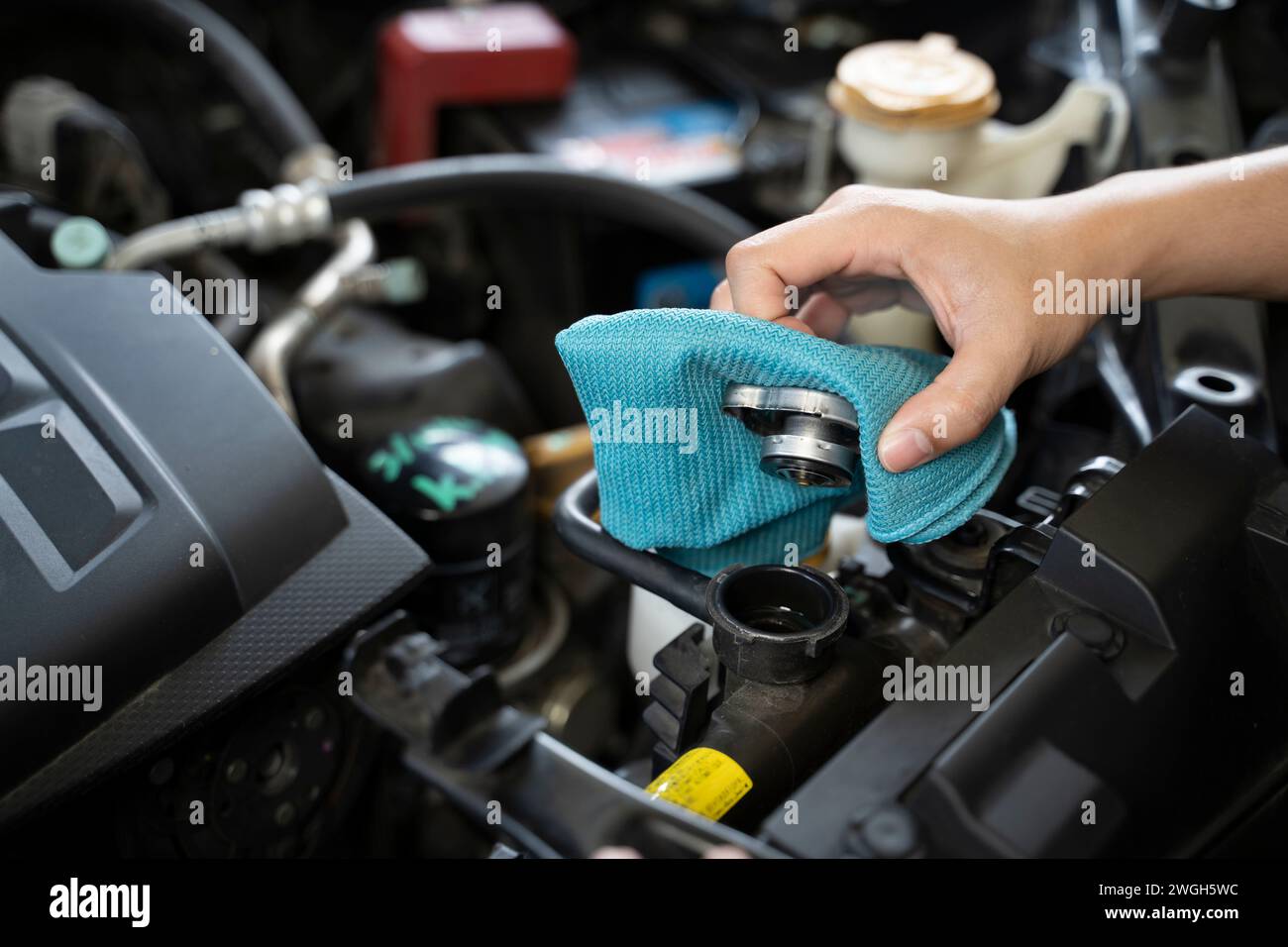 A woman is checking the engine coolant level Stock Photo - Alamy