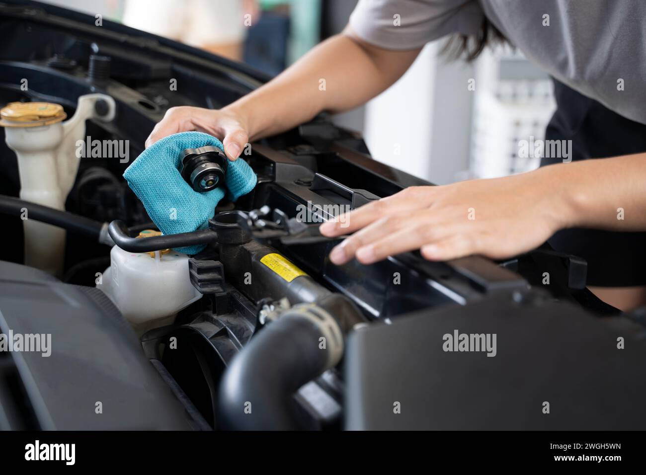A woman is checking the engine coolant level Stock Photo - Alamy