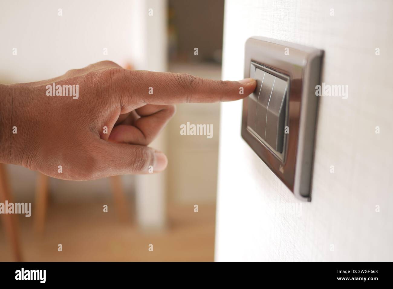 A finger turning on lighting switch Stock Photo - Alamy