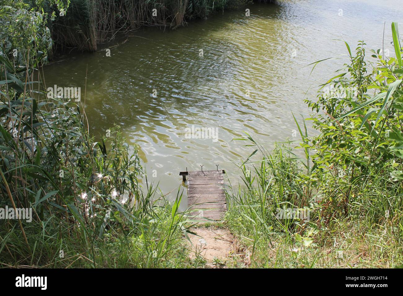 Fishing lake weak pier Stock Photo - Alamy