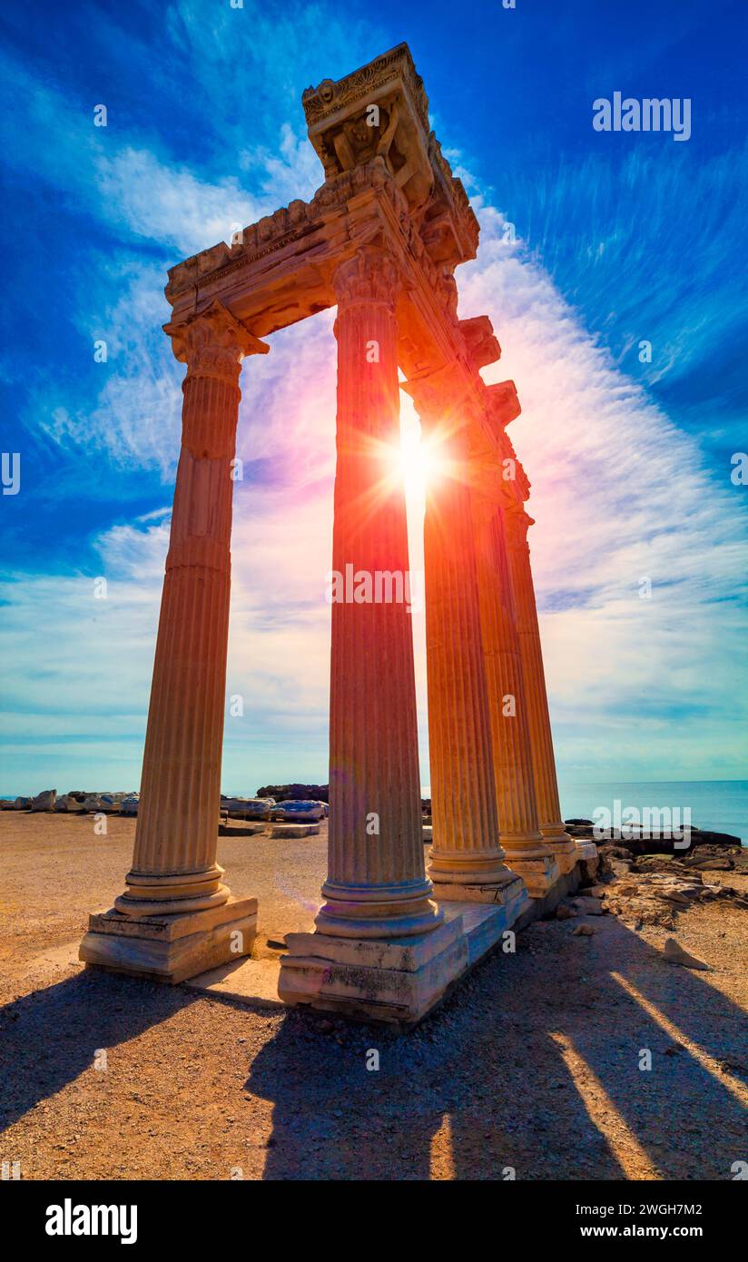 Sunset over Ancient Architectural Column and Building with Blue Sky and ...