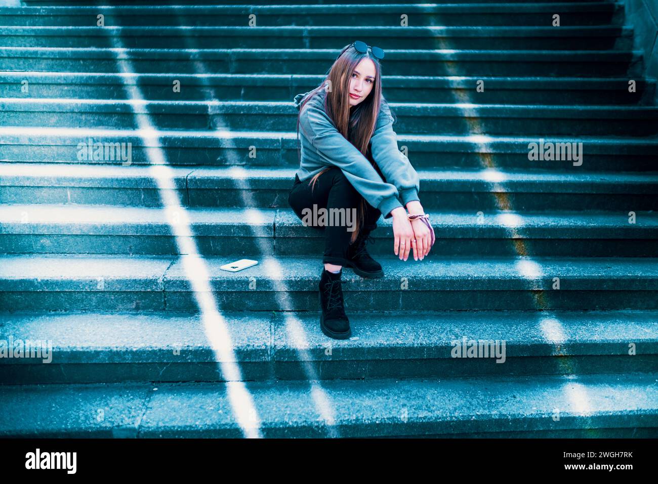 Young woman sitting stone steps outdoors hi-res stock photography and ...