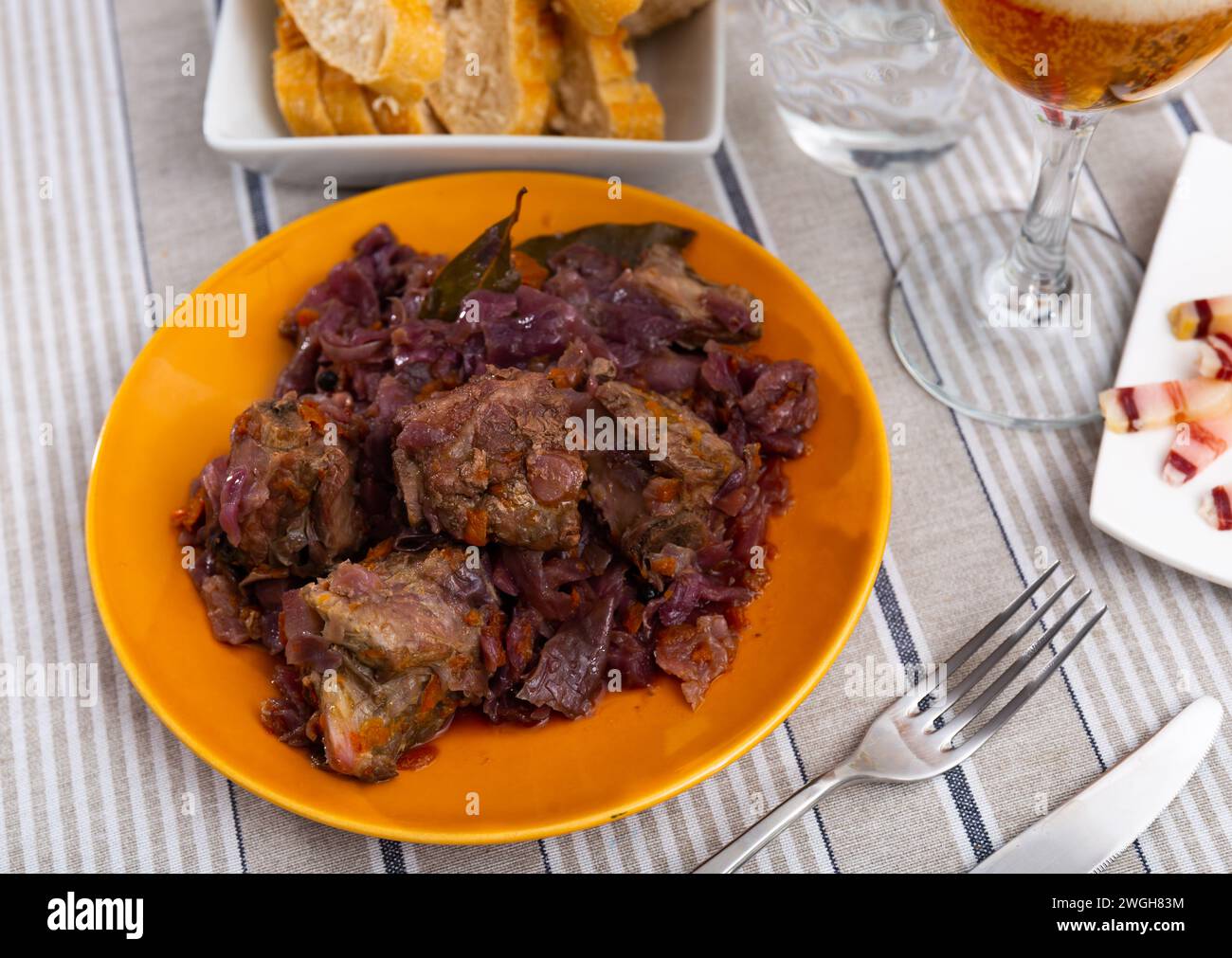 Meaty baked pork ribs with braised red cabbage Stock Photo - Alamy
