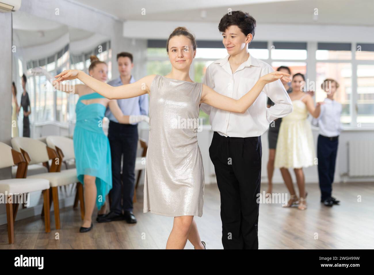 Teenage boy and girl bowing and curtsying at dance event at college ...