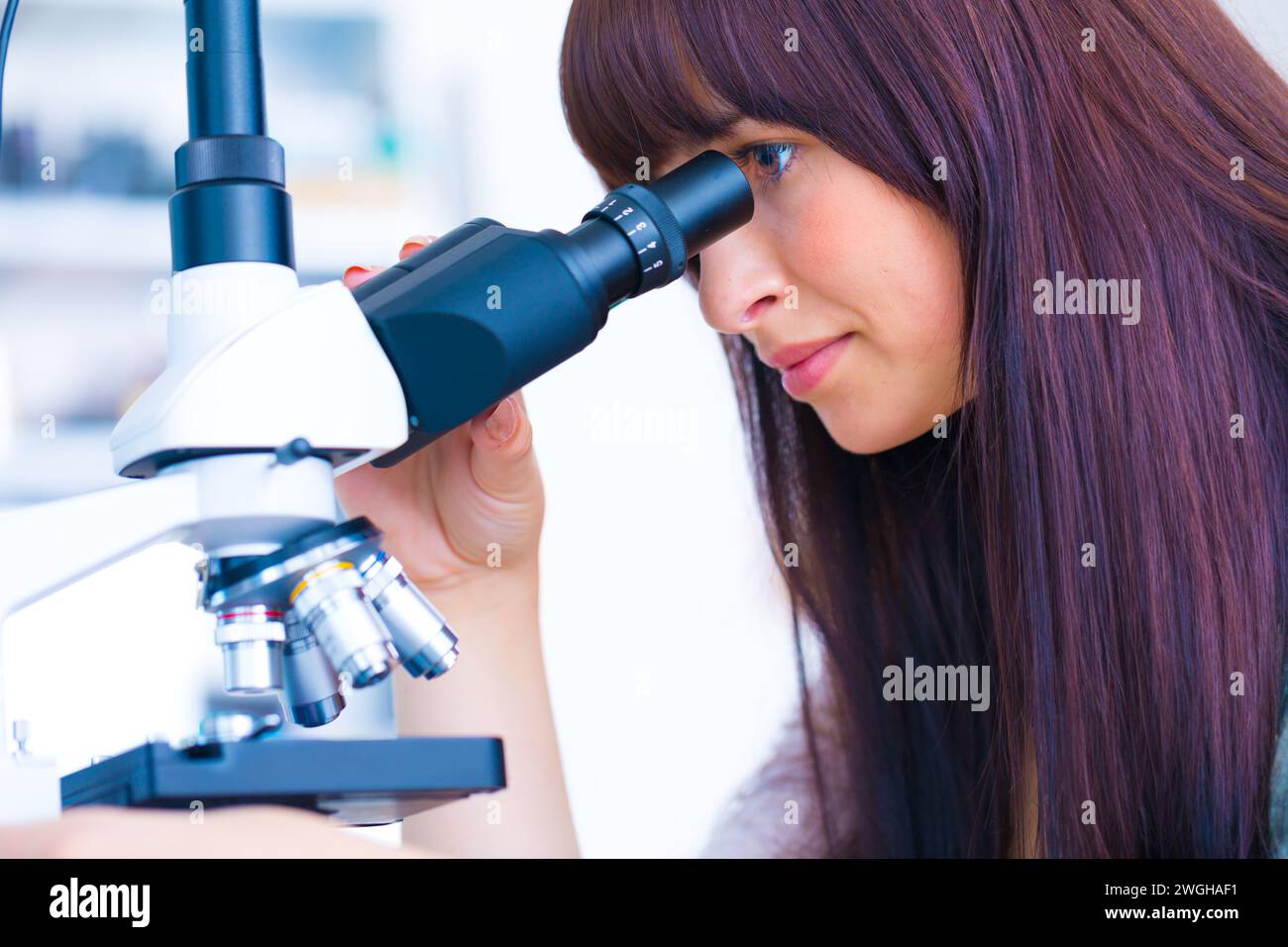 Close-up Portrait of a Young Female Scientist Looking Through a ...