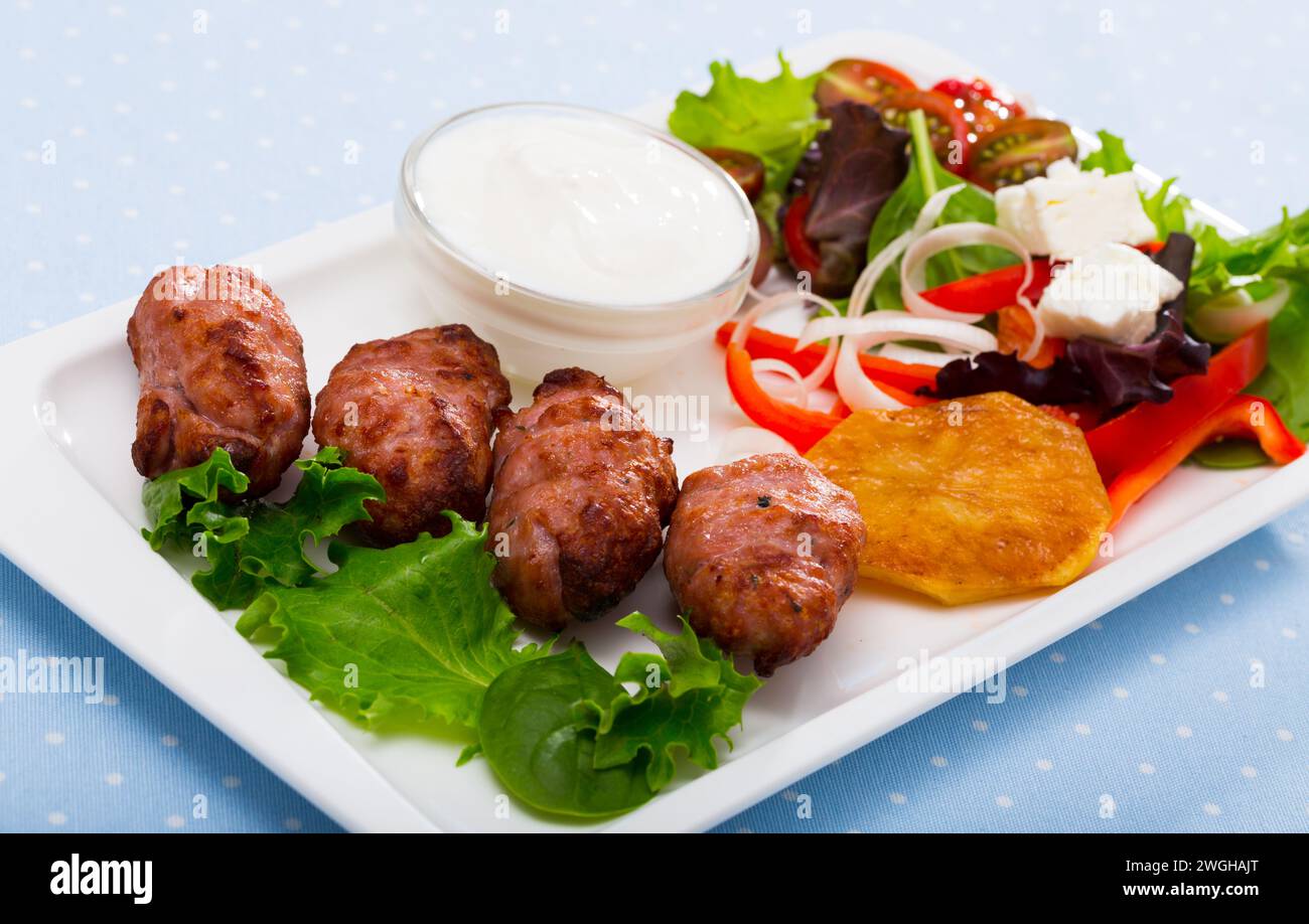 Kebapcheta served with salad Stock Photo - Alamy