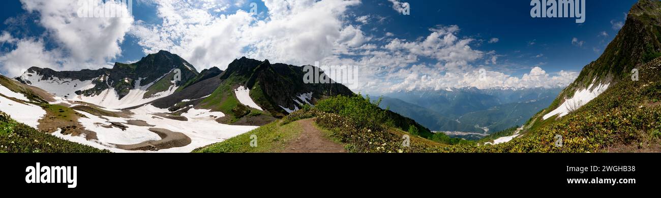 panorama of a composite landscape with green valleys and snow-capped ...
