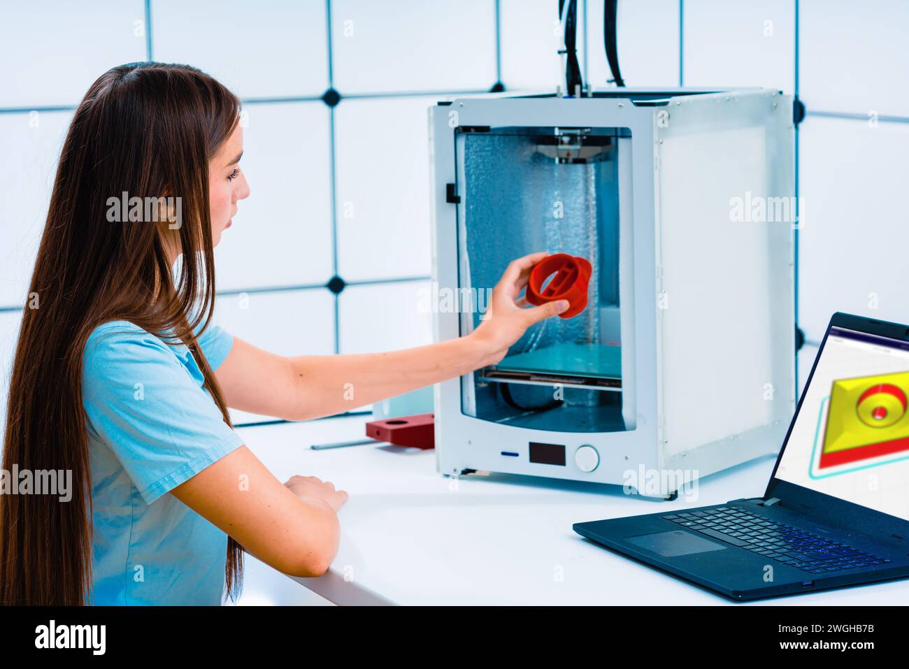 Engineer prints a prototype model on a 3d printer in a laboratory using ...