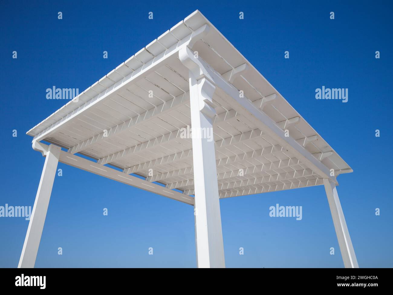 white wooden canopy for protection from the sun on a background of blue ...