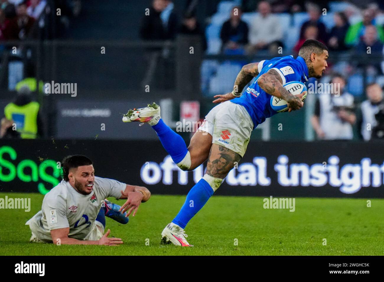 Rome, Italy. 03rd Feb, 2024. Monty Ioane of Italy is held by Ethan ...