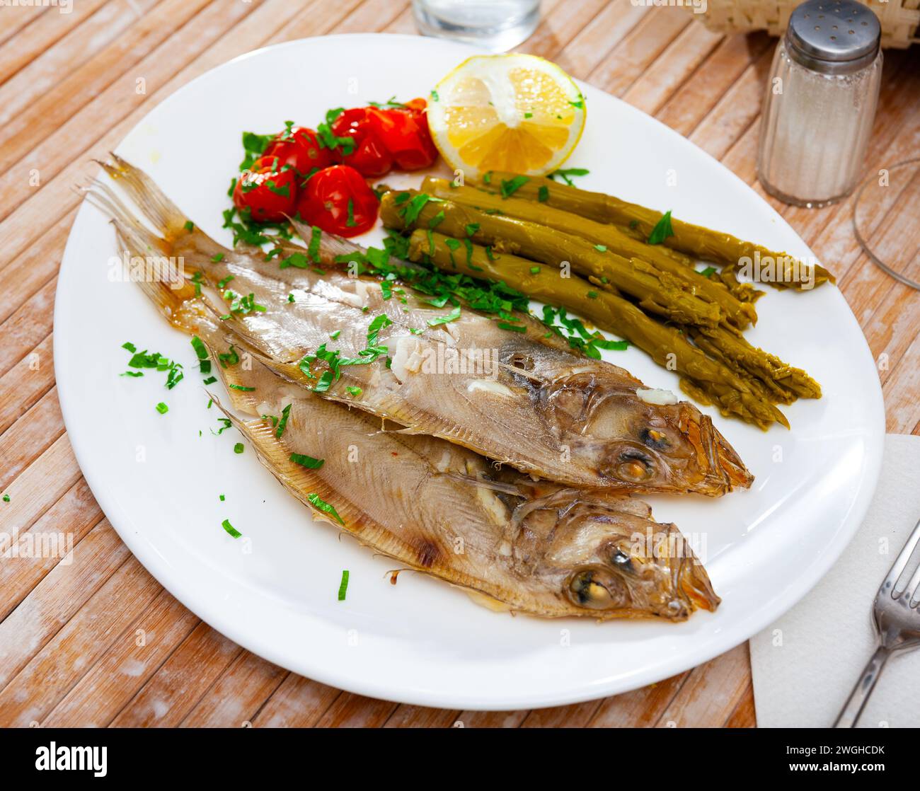 Oven baked rooster fish with marinated asparagus Stock Photo - Alamy