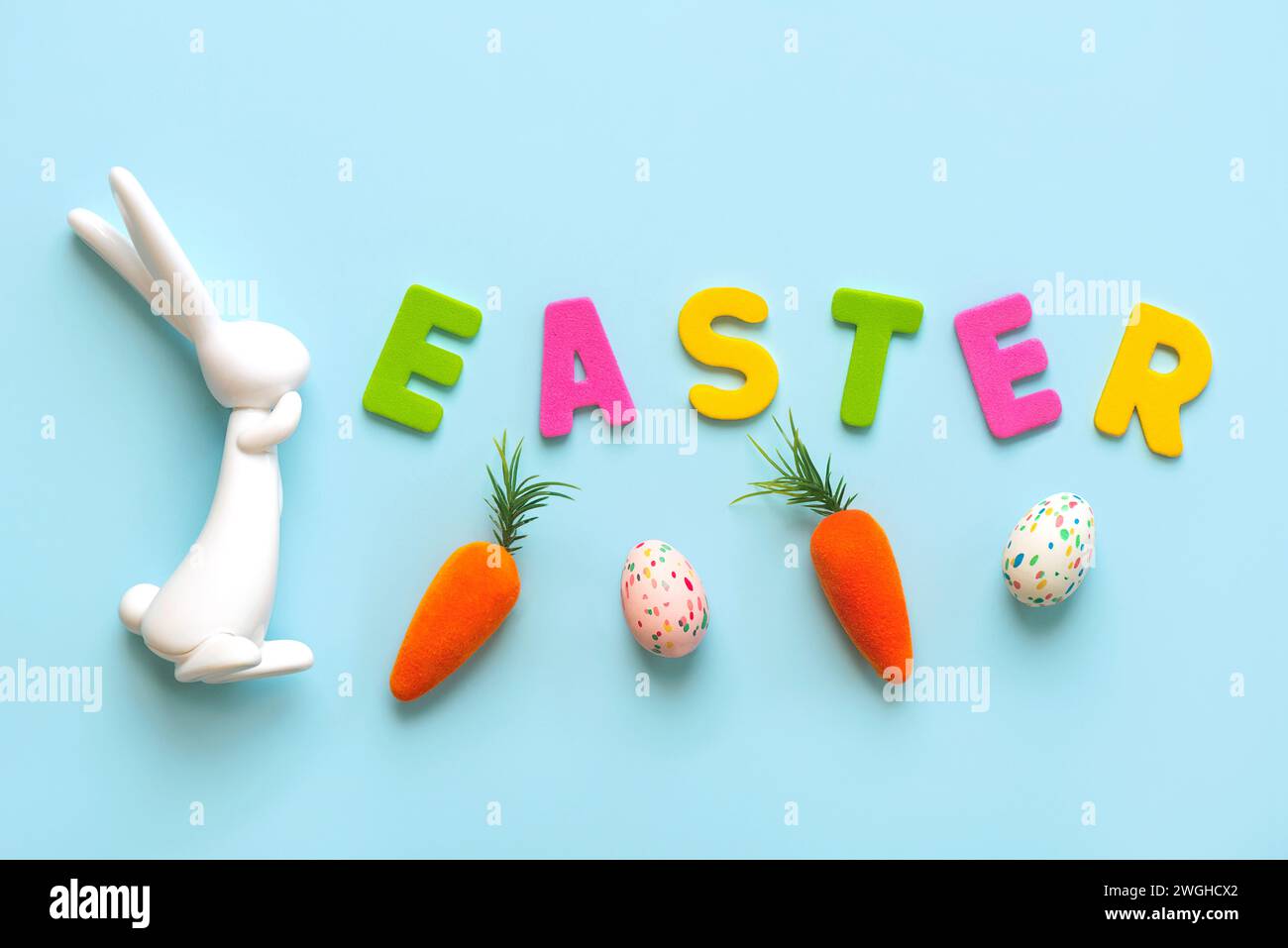 Happy Easter. Easter bunny with carrots,easter eggs and colored letters ...