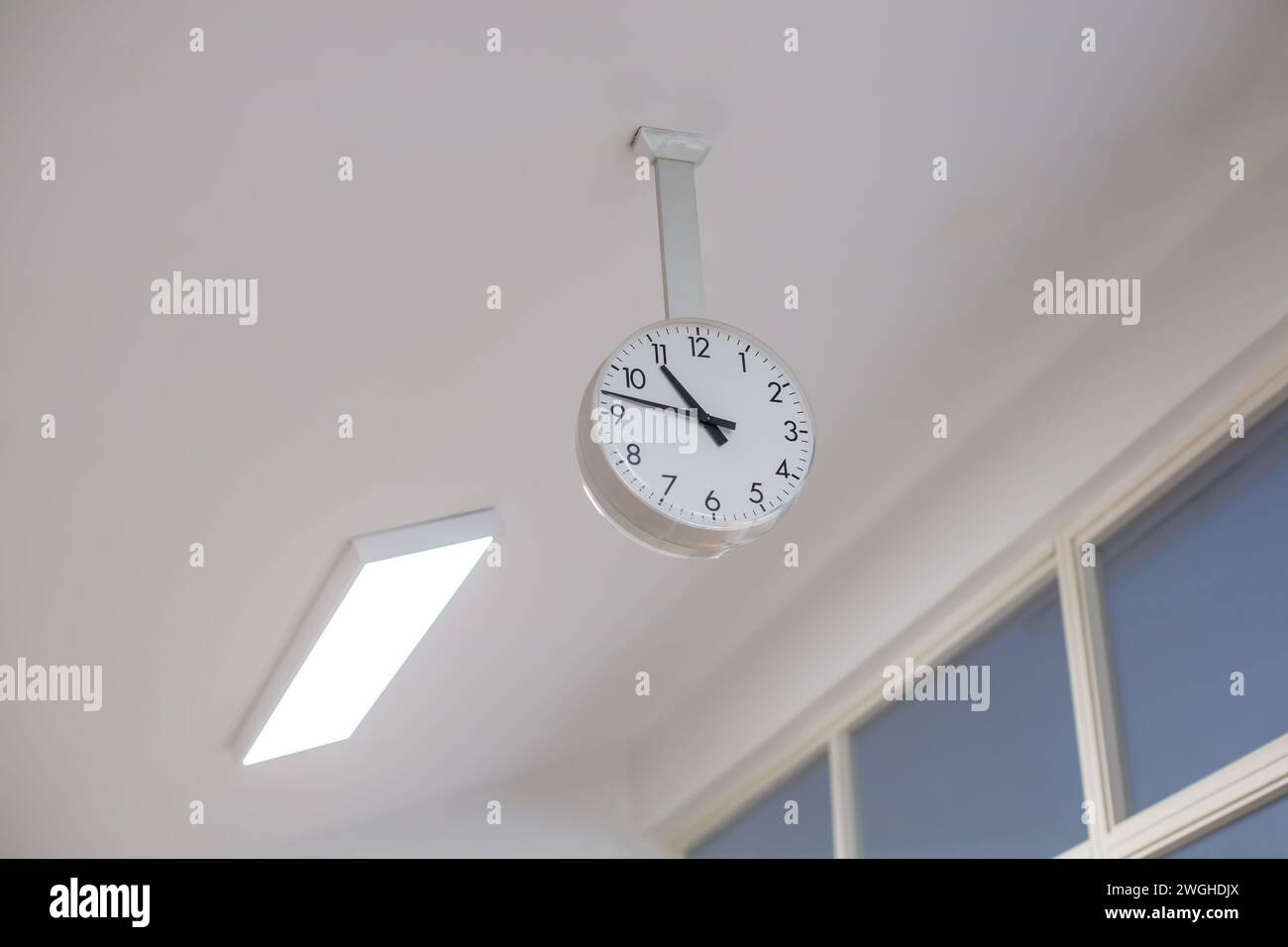 large analog clock hanging from ceiling Stock Photo - Alamy