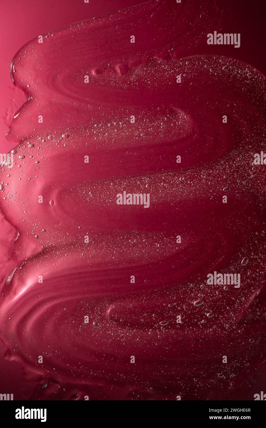 Abstract gel structure with air bubbles on dark magenta background ...