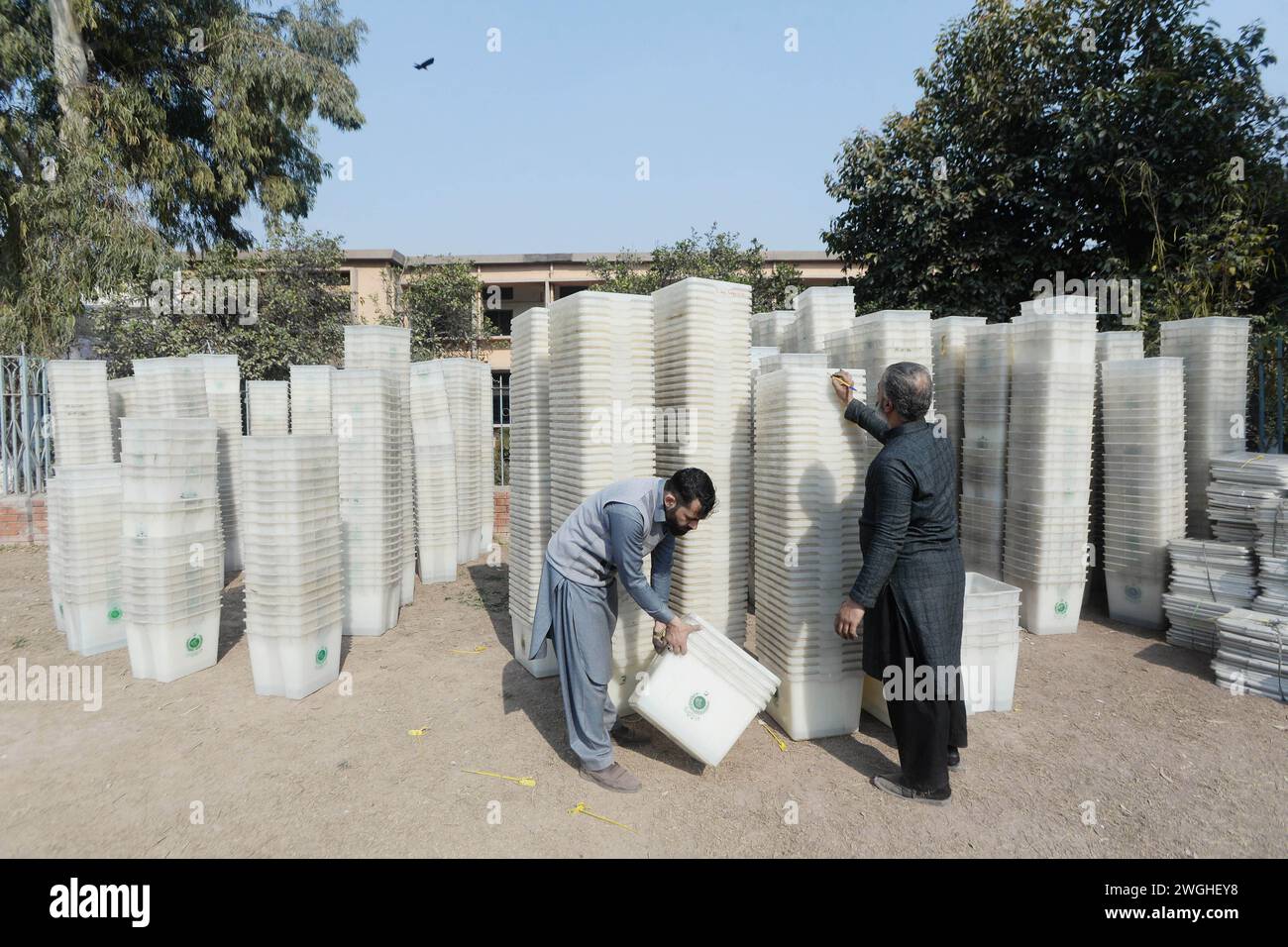 Peshawar. 5th Feb, 2024. Workers sort ballot boxes to be sent to ...