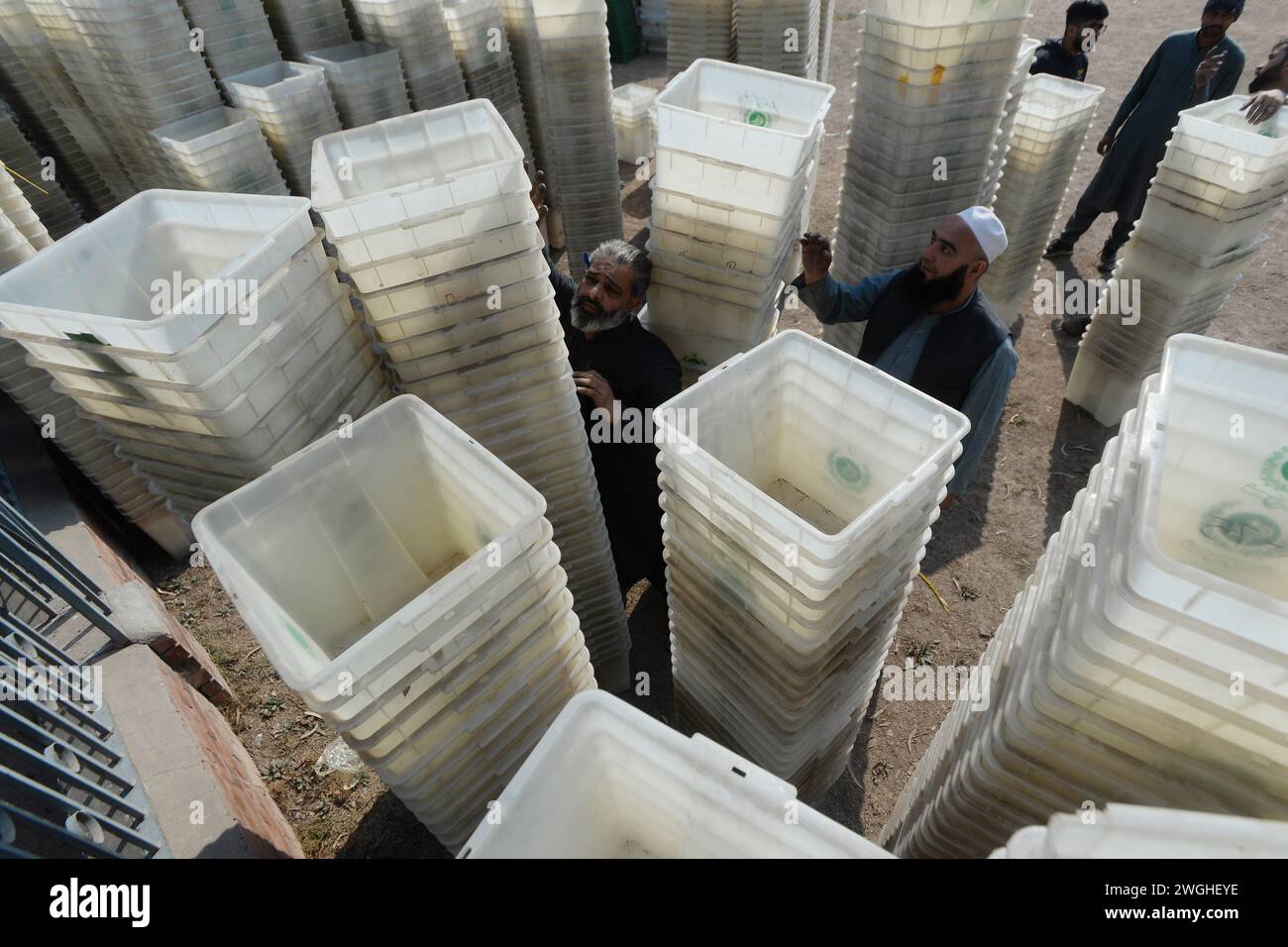Peshawar. 5th Feb, 2024. Workers sort ballot boxes to be sent to ...