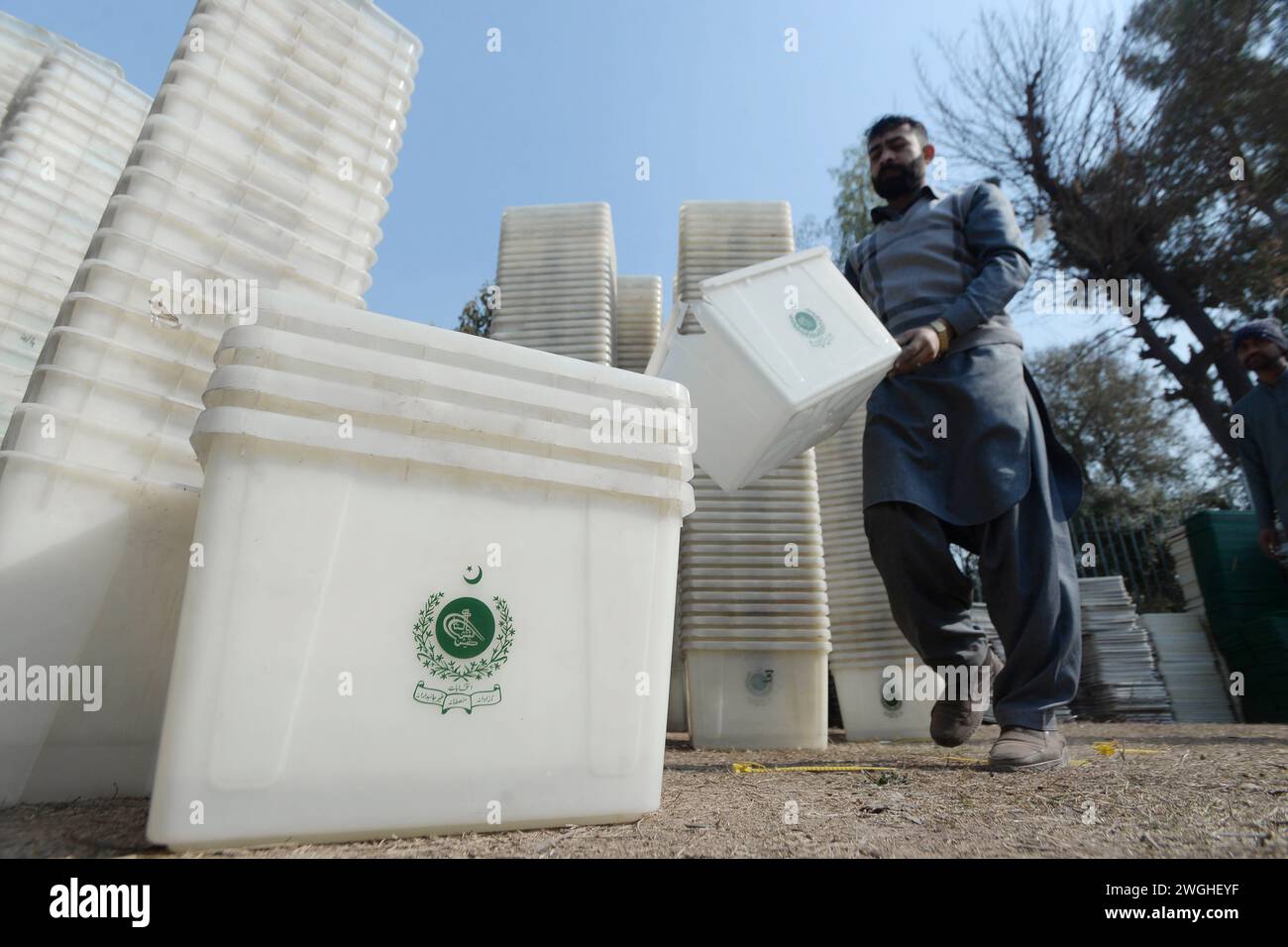 Peshawar. 5th Feb, 2024. A worker sorts ballot boxes to be sent to ...