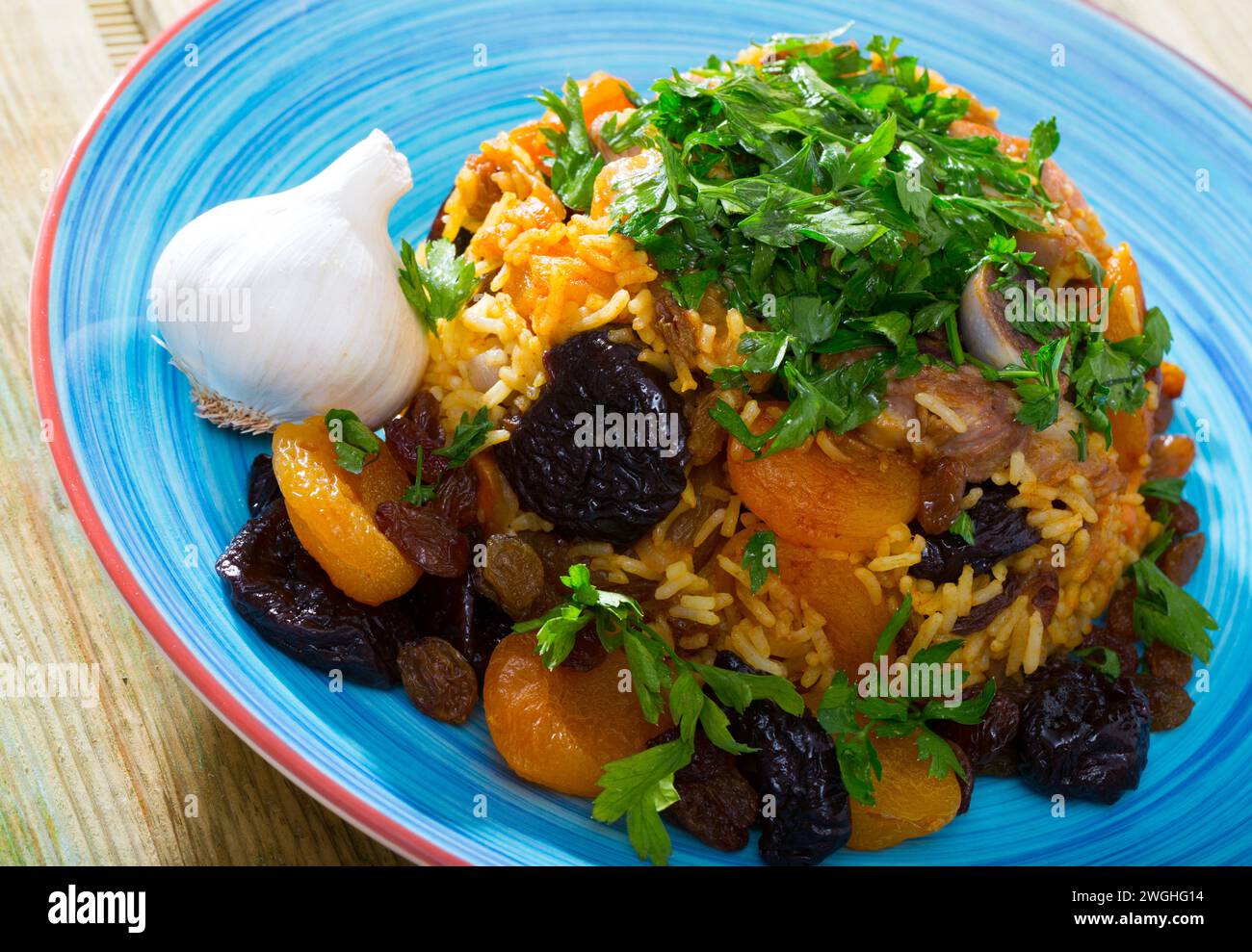 Lamb pilau with dried fruits and greens Stock Photo - Alamy
