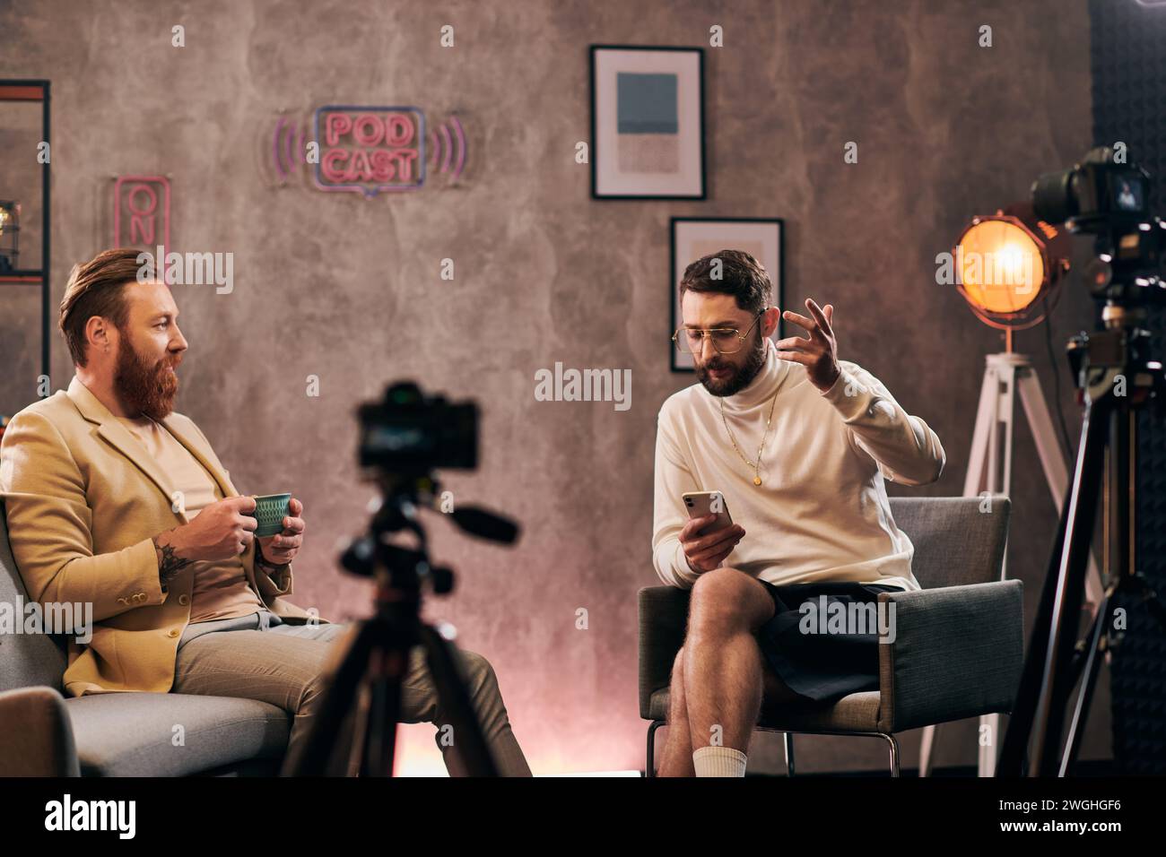 good looking elegant men in chic attires with beards talking during ...