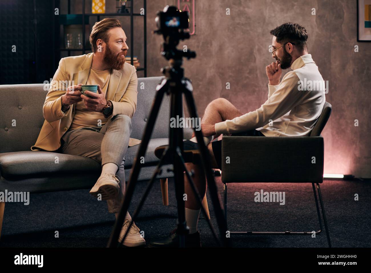 dedicated men with beards in elegant attires sitting and discussing ...
