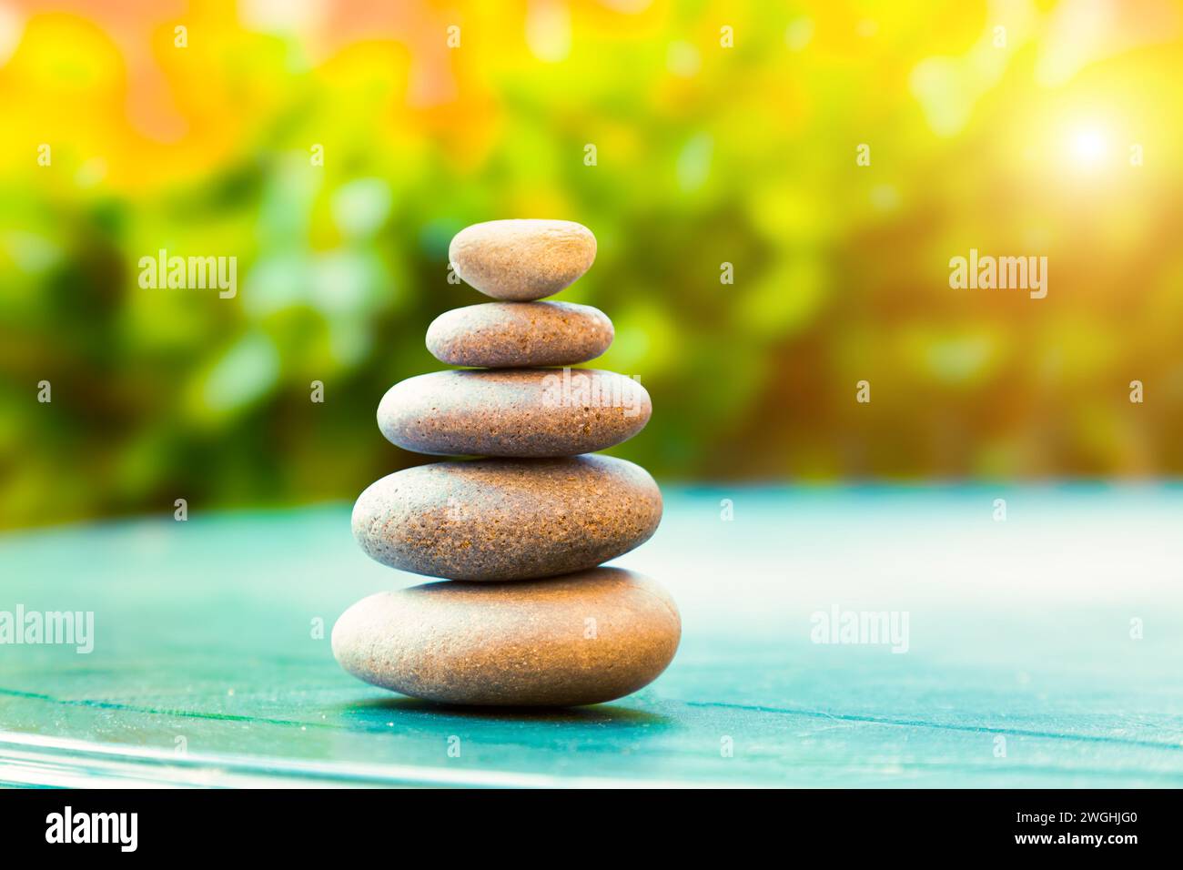 Stone pyramid made from river pebbles Bright Yellow Stone on Calm Rock ...