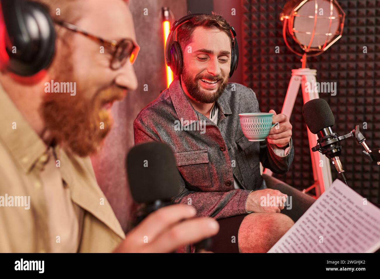 two bearded handsome men in casual attires with headphones talking ...