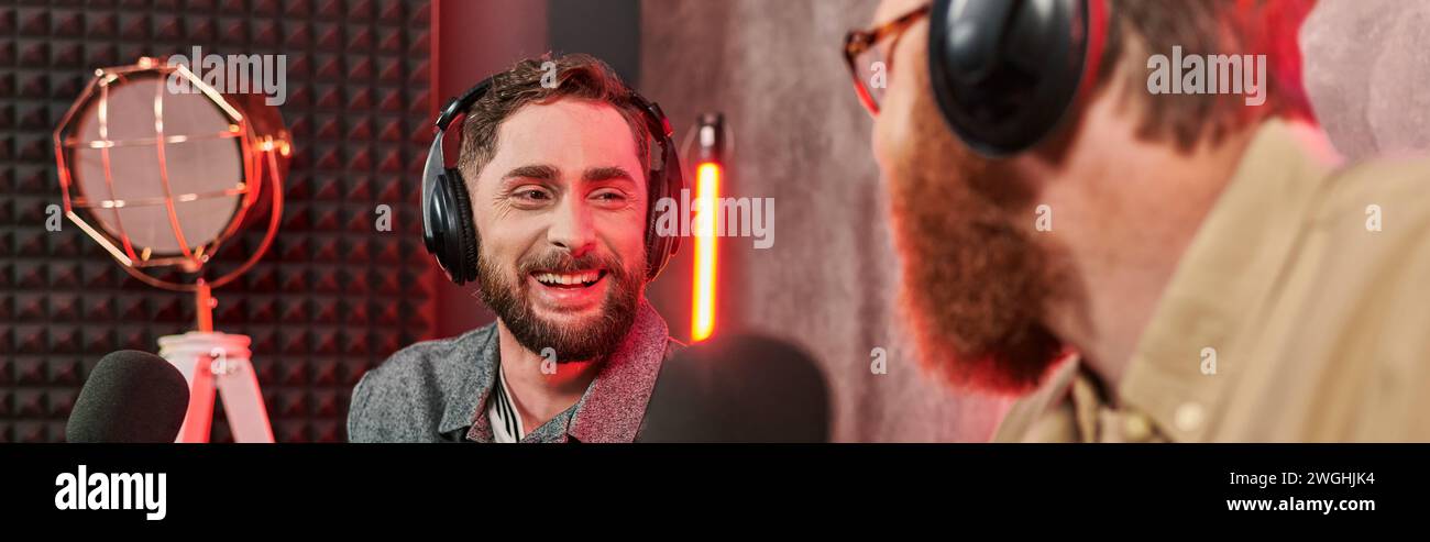 bearded handsome men in stylish attires with headphones talking ...
