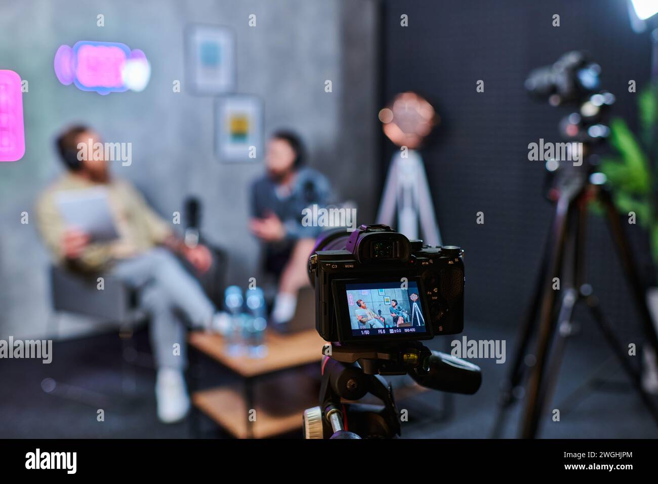 focus on camera filming stylish blurred men with beards in headphones ...