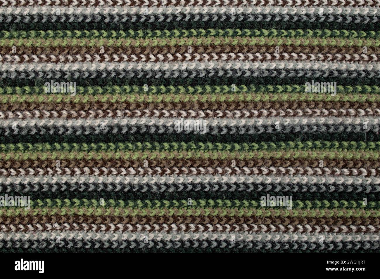 crochet fabric texture with brown, gray, green and black colored lines ...