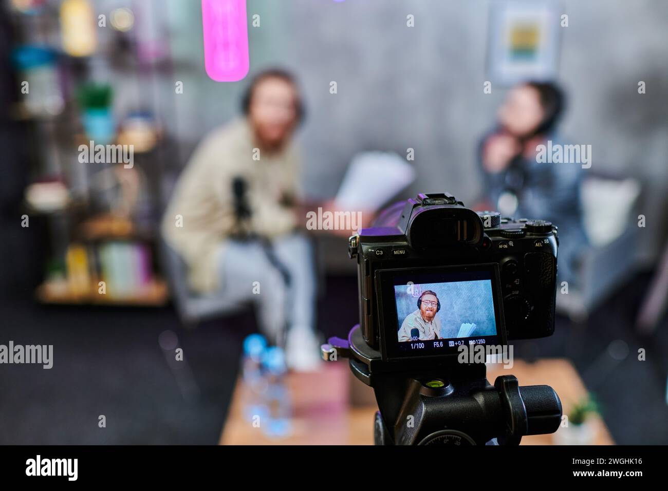 focus on camera filming handsome blurred men with beards in headphones ...