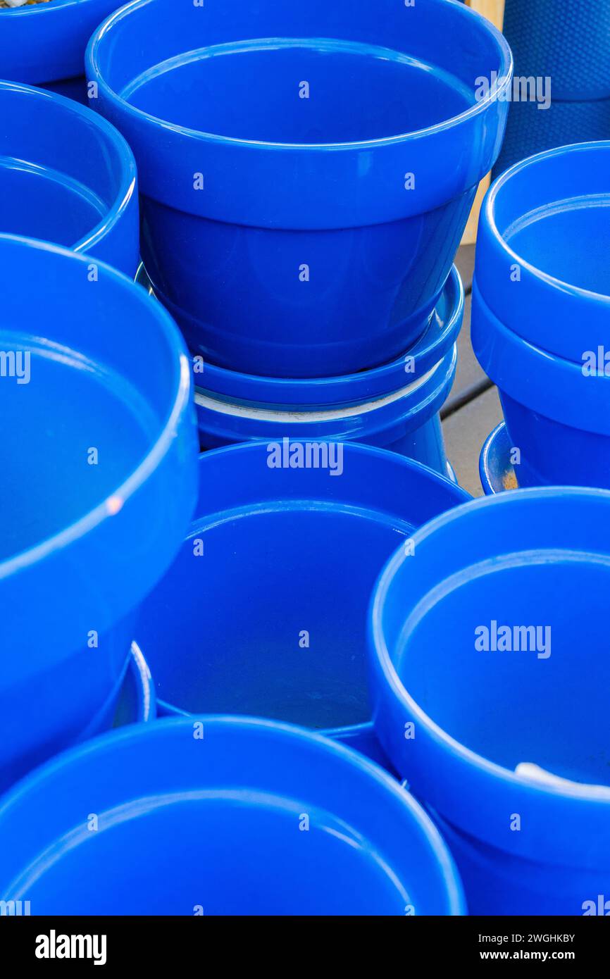 Bright blue ceramic plant pots at local nursery Stock Photo - Alamy