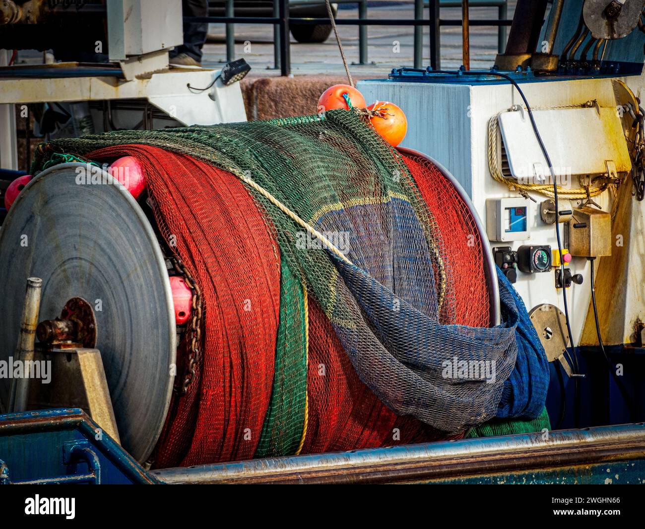 close up view of rolled up fishing net on a winch aboard a small ...