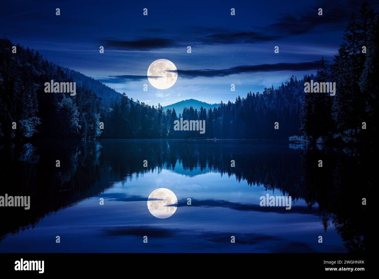 moon reflecting on the water surface of a lake. night scene with dark ...