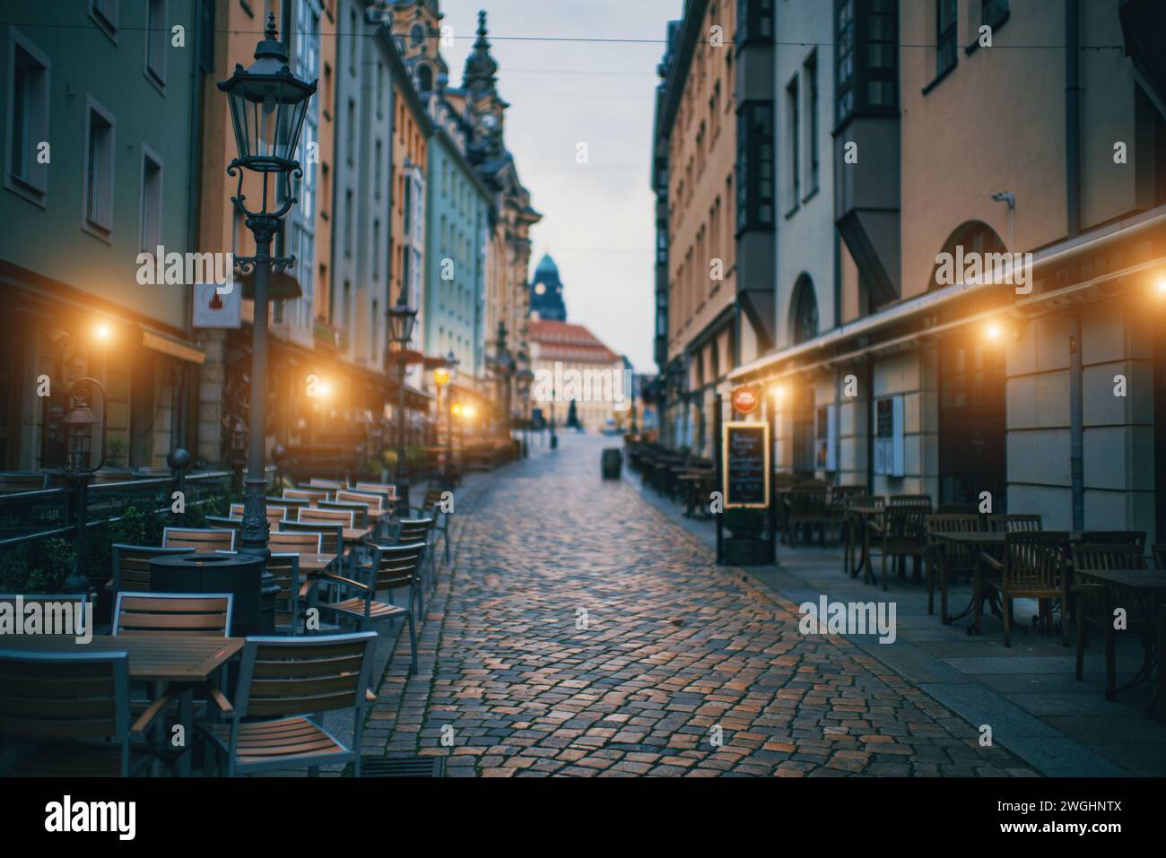 Evening City Street with Illuminated Buildings and Sidewalk Cafes Stock ...